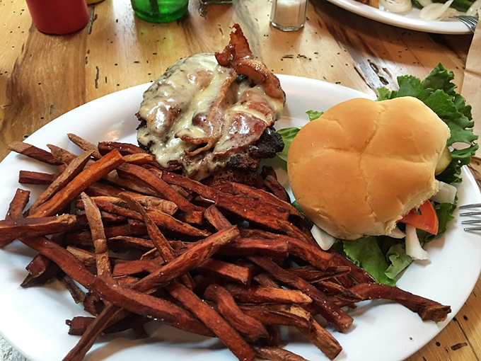 A bacon cheeseburger with sweet potato fries &ndash; proof that sometimes the simplest pleasures are the most profound.