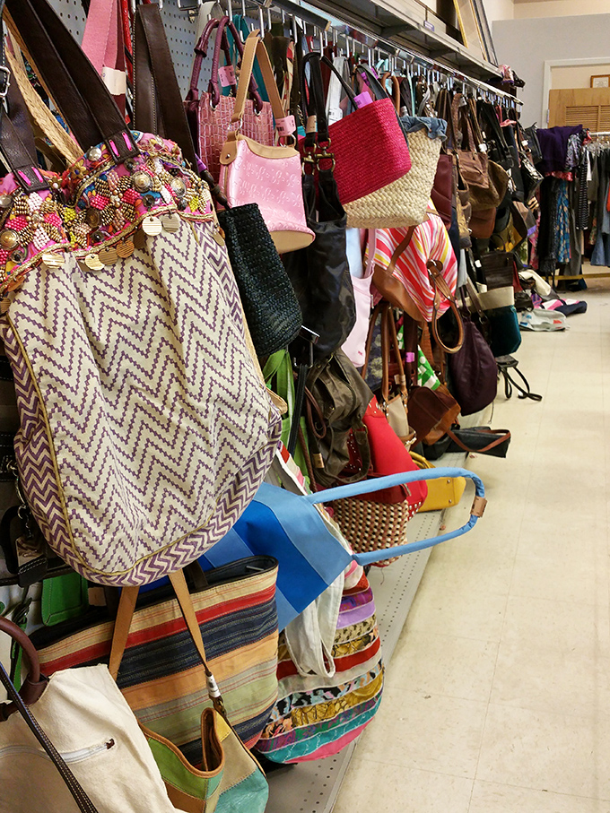 A kaleidoscope of handbags dangles in suspended animation, each with stories from previous lives waiting to be continued.