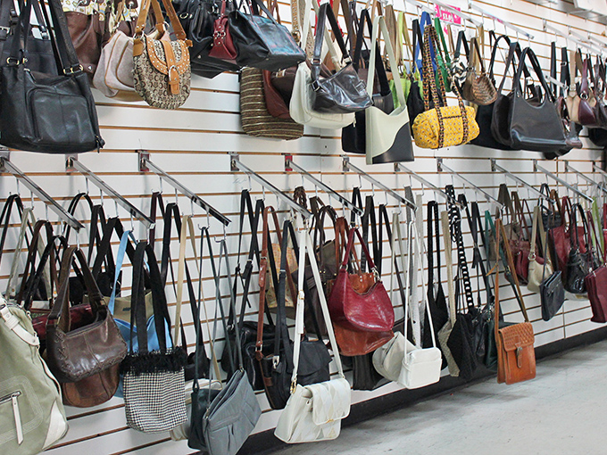 Handbag heaven! A leather lover's dream where yesterday's designer splurges become today's steals, hanging like fashionable fruit ready for picking.