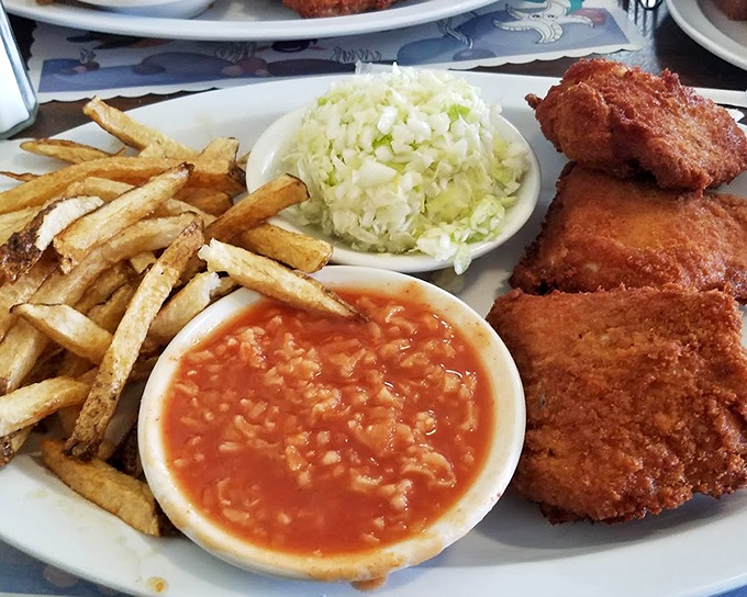 The distinctive rice-flecked hot sauce isn't just a condiment &ndash; it's a cultural statement, a tangy counterpoint to the richness that makes Barberton chicken legendary.