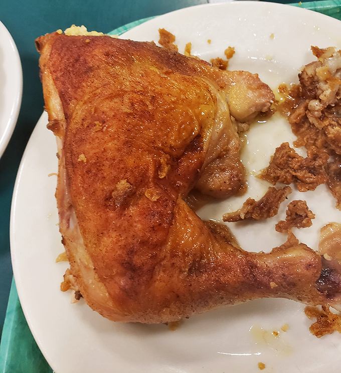 This chicken leg, bronzed to perfection, proves that sometimes the simplest preparations yield the most profound culinary pleasures.