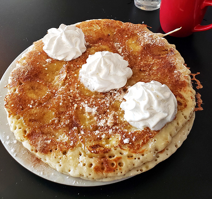 These aren't just pancakes&mdash;they're fluffy golden discs of joy topped with whipped cream clouds. Breakfast that makes you forget all your troubles.