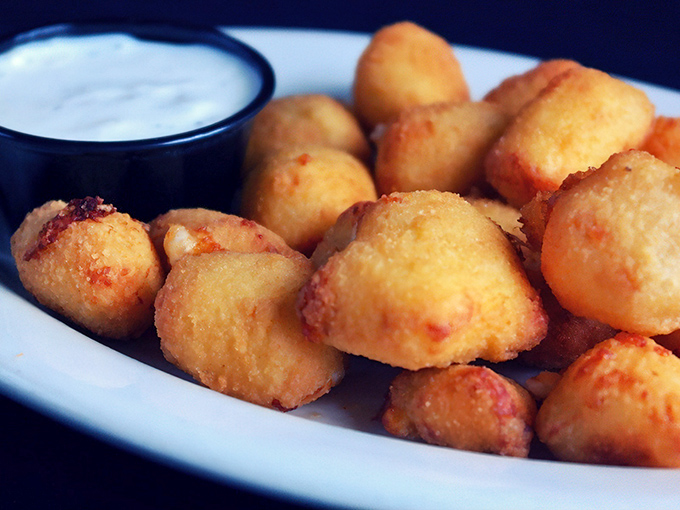 Wisconsin's unofficial state treasure&mdash;cheese curds fried to golden perfection, waiting to unleash that distinctive squeak-then-melt magic with every bite. 
