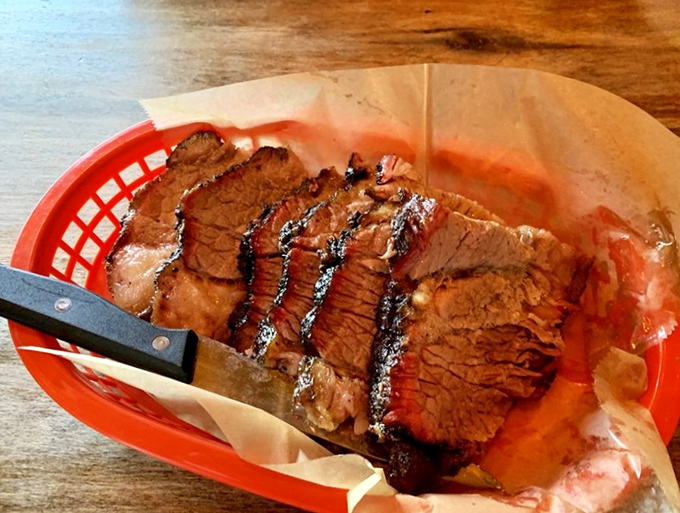 Brisket sliced so perfectly you could read a newspaper through it, with a smoke ring that's basically barbecue jewelry.