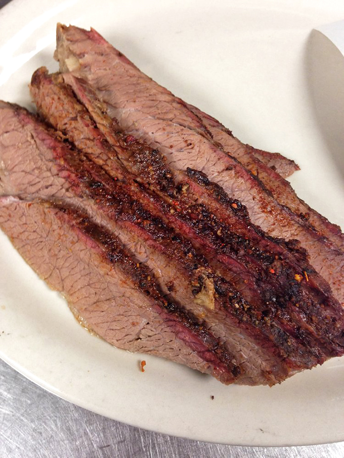Brisket sliced so perfectly you could read a newspaper through it. That bark has more character than most Hollywood scripts these days.