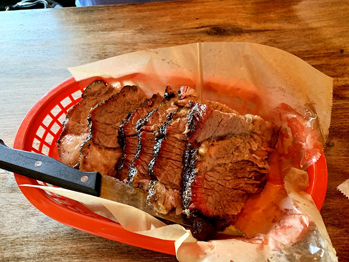 Brisket with a smoke ring so perfect it could be framed in a museum of meat masterpieces.