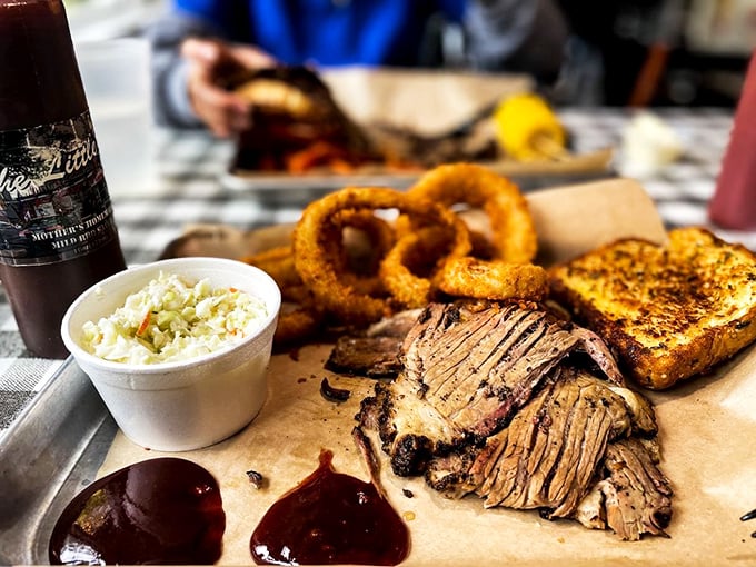 Brisket with that perfect smoke ring sitting alongside crispy onion rings &ndash; proof that Mississippi understands the art of BBQ diplomacy.