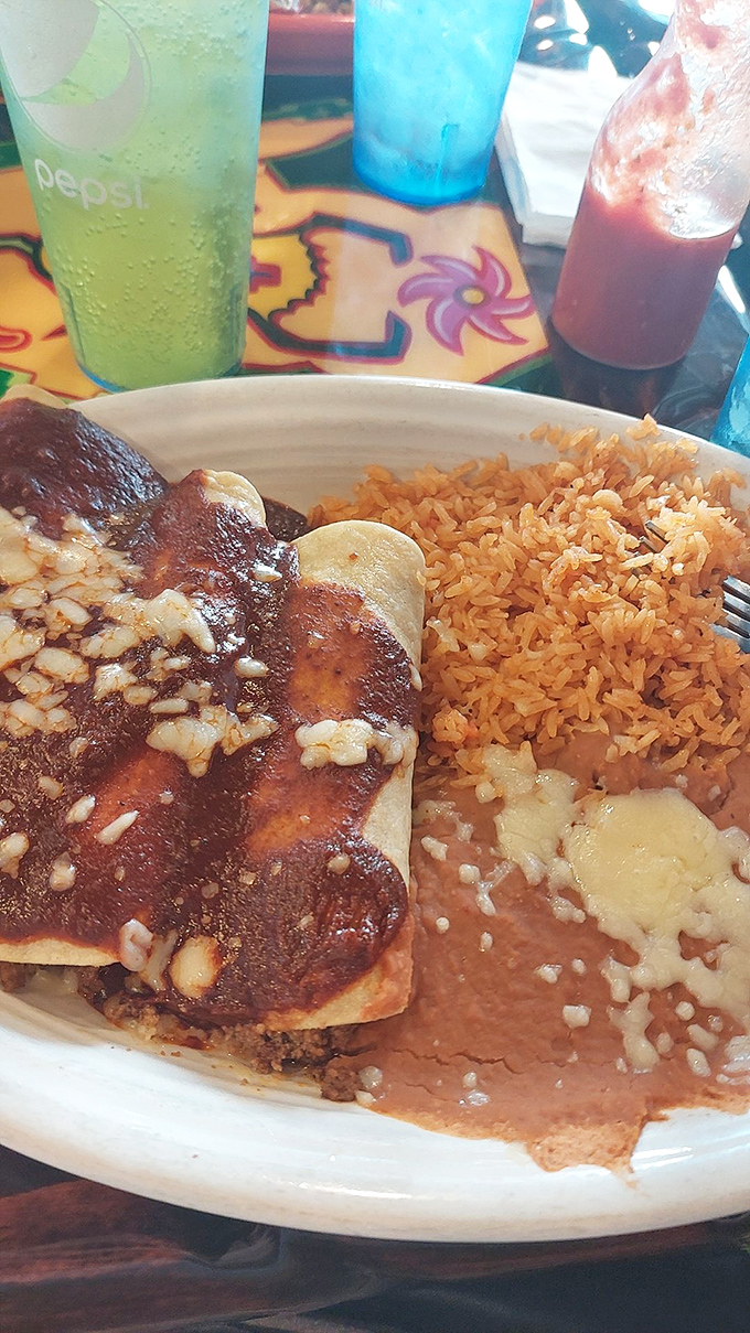Red sauce cascading over a perfectly rolled enchilada like lava from a delicious volcano. The rice and beans aren't sidekicks&mdash;they're co-stars.