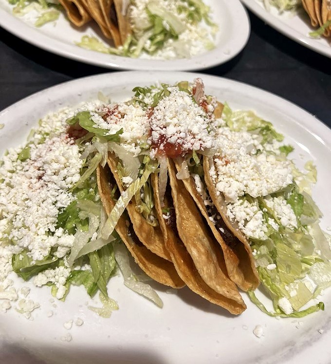 Crispy tacos dusted with cotija cheese and nestled on fresh lettuce&mdash;proof that simplicity, when done right, is the ultimate sophistication.