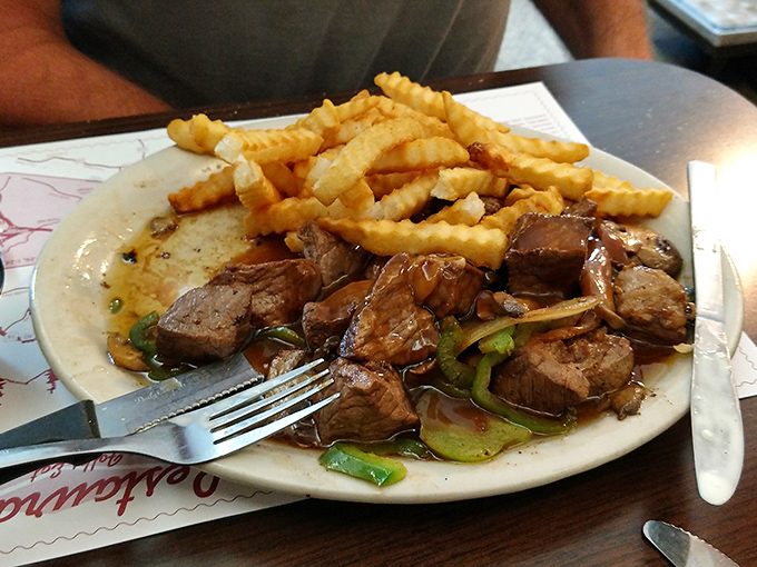 Tender beef tips swimming in savory gravy alongside golden fries &ndash; proof that sometimes the simplest combinations create the most profound happiness.