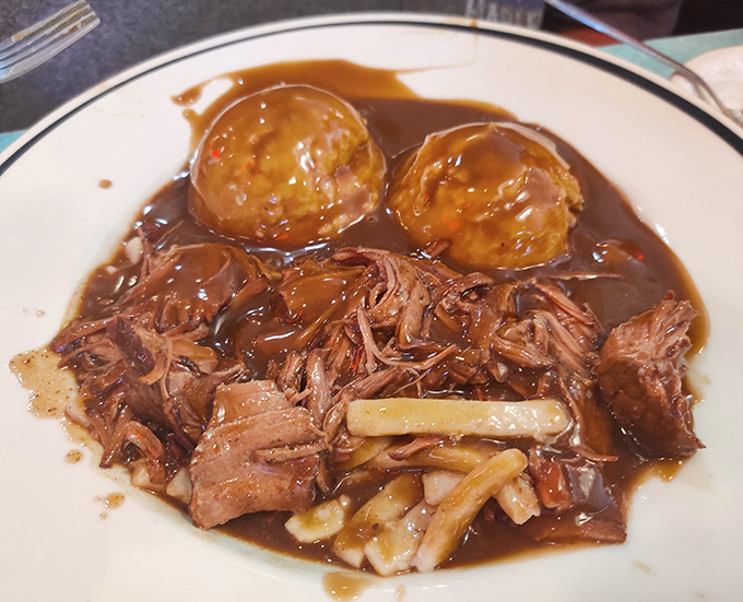 The beef and noodles arrive like a warm hug on a plate, tender meat surrendering to its rich gravy bath.