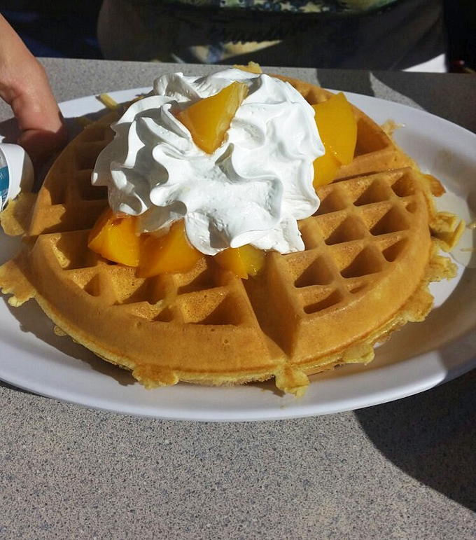 Waffle architecture at its finest! Crisp exterior, fluffy interior, topped with fresh fruit and whipped cream&mdash;breakfast that doubles as dessert.