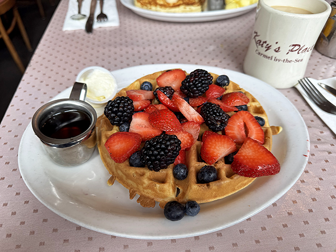 A Belgian waffle crowned with fresh berries looks like summer decided to throw a party on your plate.