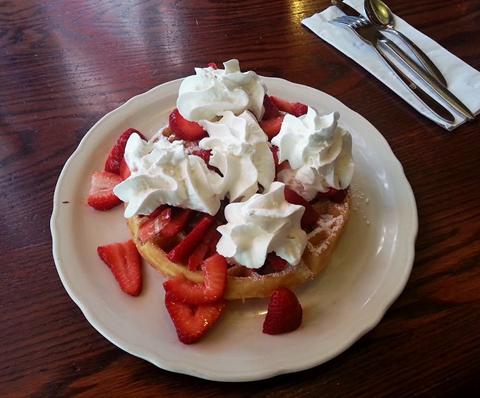 A Belgian waffle crowned with fresh strawberries and whipped cream &ndash; breakfast masquerading as dessert, and nobody's complaining.
