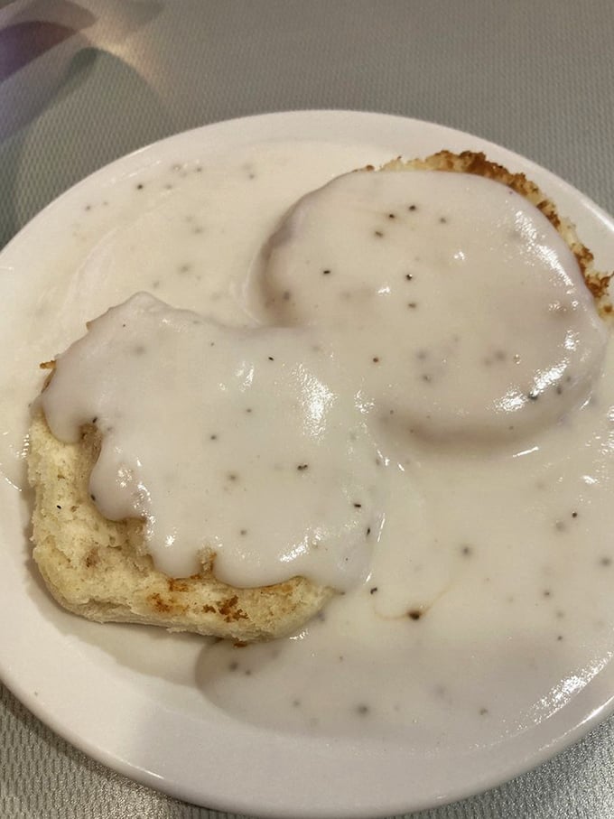 Biscuits and gravy so good they should require a permission slip. That pepper-speckled country gravy doesn't just cover—it embraces.