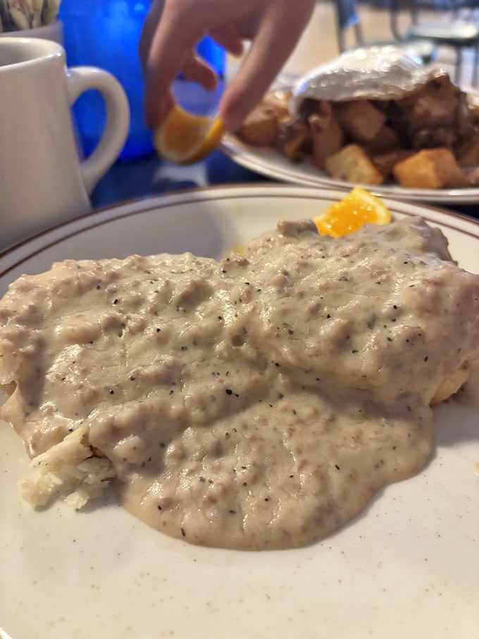 The legendary biscuits and gravy &ndash; where peppery cream sauce cascades over flaky homemade goodness like a Southern waterfall.
