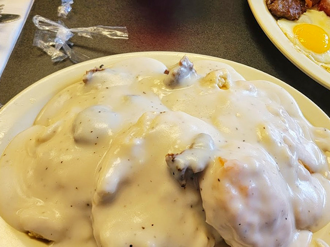 Biscuits and gravy: the Southern equivalent of a warm hug, where pillowy bread disappears beneath a creamy blanket that's been perfected over generations.