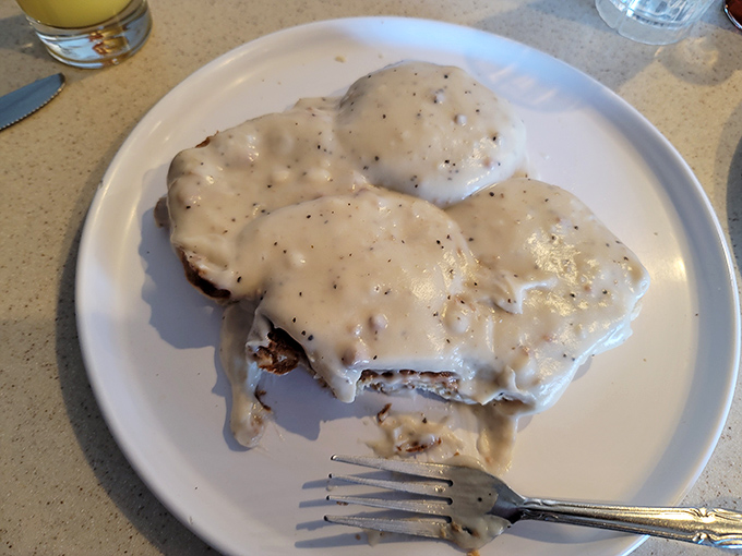 Smothered in creamy, pepper-flecked gravy, these biscuits aren't trying to win any beauty contests—they're too busy winning your heart instead.