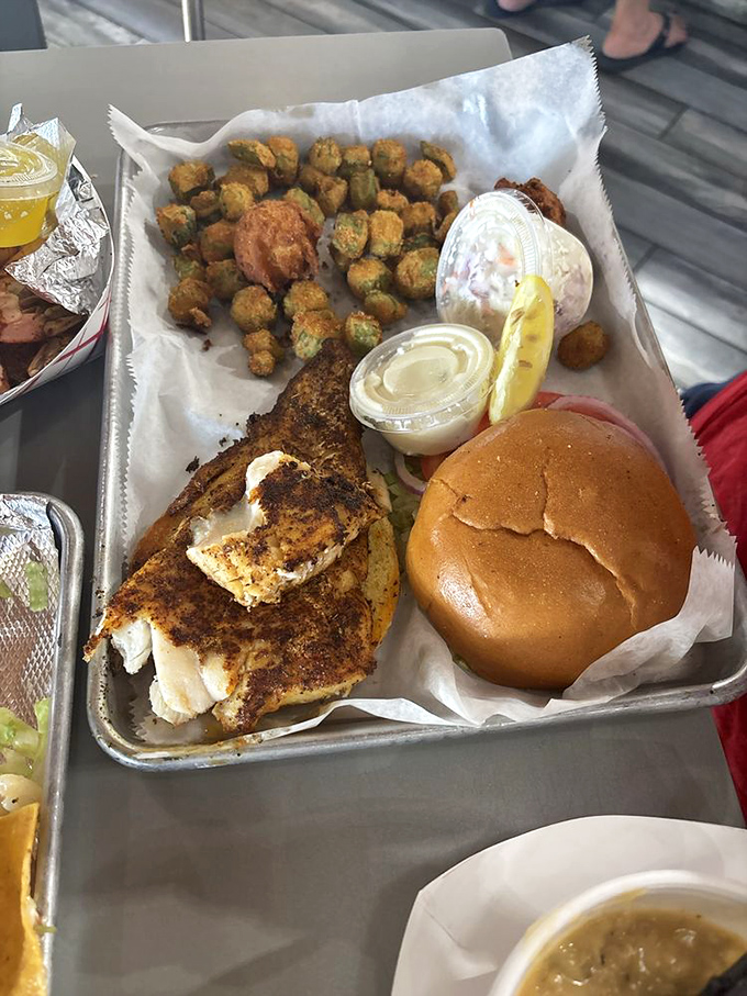 The blackened grouper sandwich – where Florida's finest fish meets a perfectly toasted bun in a relationship that makes all other sandwiches jealous.