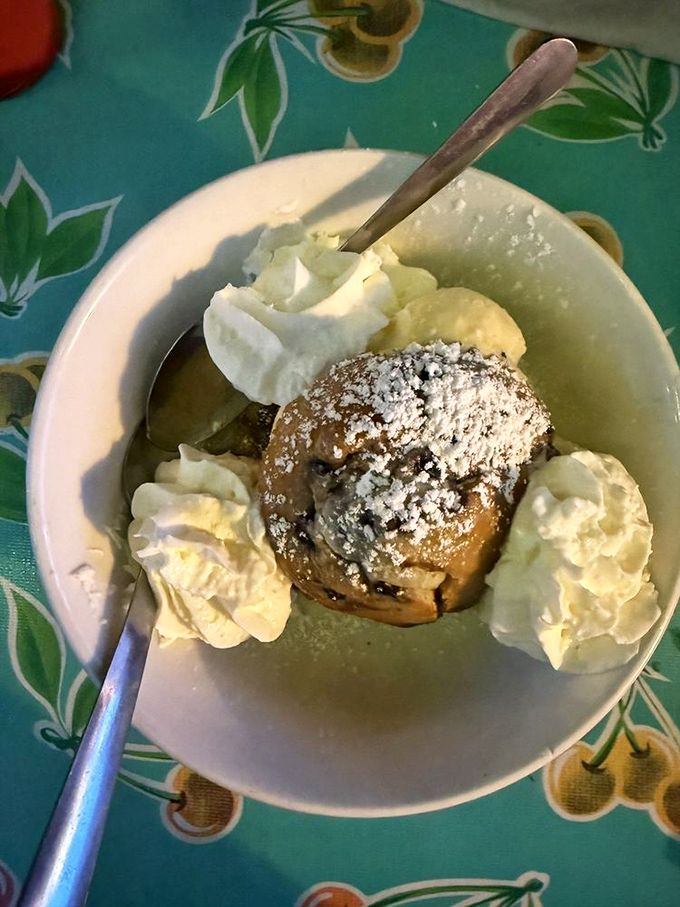 A blueberry muffin surrounded by whipped cream like a tiny dessert island in a sea of deliciousness. Breakfast? Dessert? Why choose?