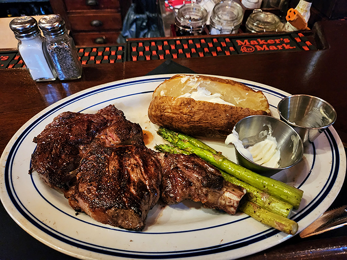 The bone-in ribeye&mdash;where primal meets refined. That char speaks of fire-kissed perfection while the asparagus stands by, pretending it's the reason you came.