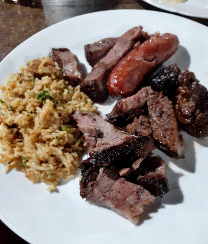 The holy trinity of Brazilian cuisine: perfectly seasoned rice, lingui&ccedil;a sausage, and grilled steak. Simplicity elevated to an art form that needs no translation.