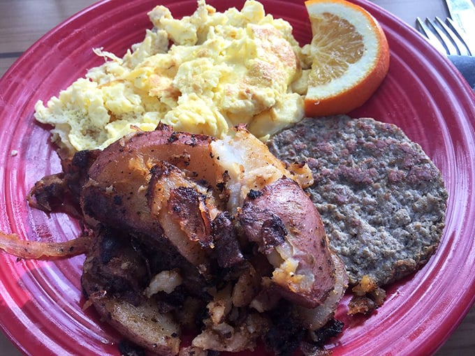 Morning glory on a plate! Perfectly scrambled eggs alongside home fries and sausage patty &ndash; the breakfast trifecta that makes getting out of bed worthwhile.