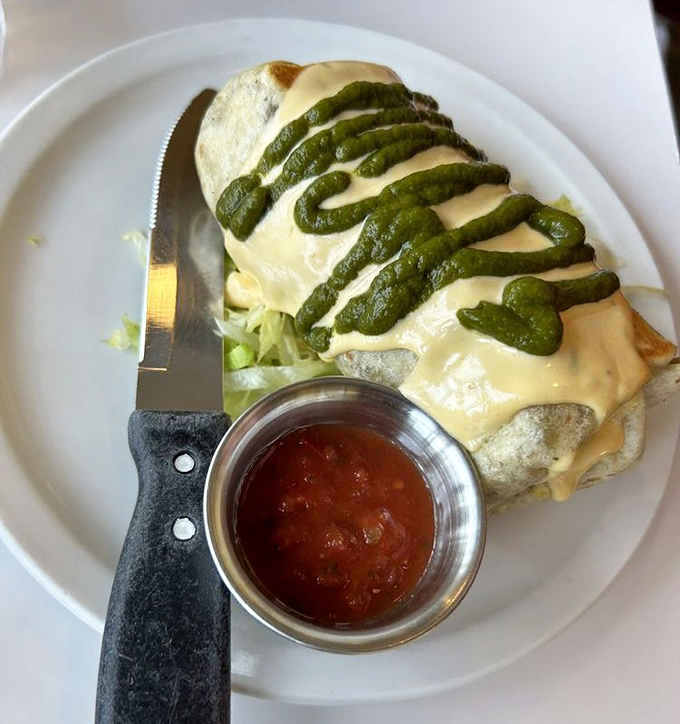 A breakfast burrito that doesn't mess around, draped in velvety green sauce. The kind of morning meal that makes you reconsider your relationship with cereal.