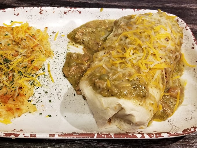 Breakfast burrito perfection: a tortilla treasure chest filled with savory goodness and topped with green chile sauce that would make New Mexico jealous.