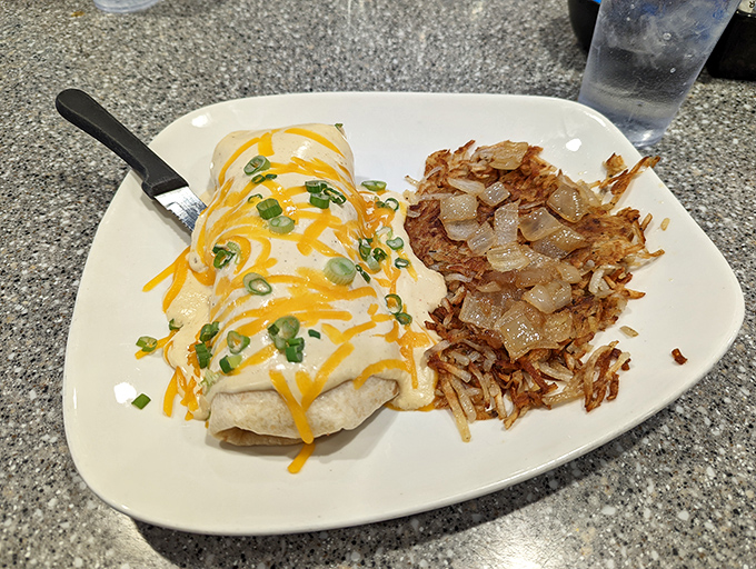 Their breakfast enchilada brings morning sunshine to Mexican cuisine, topped with melty cheese and green onions. The hash browns aren't playing second fiddle.
