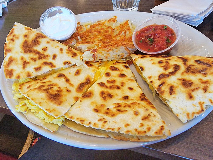 The breakfast quesadilla arrives looking like a golden-brown masterpiece, with crispy edges and hash browns that demand immediate attention.