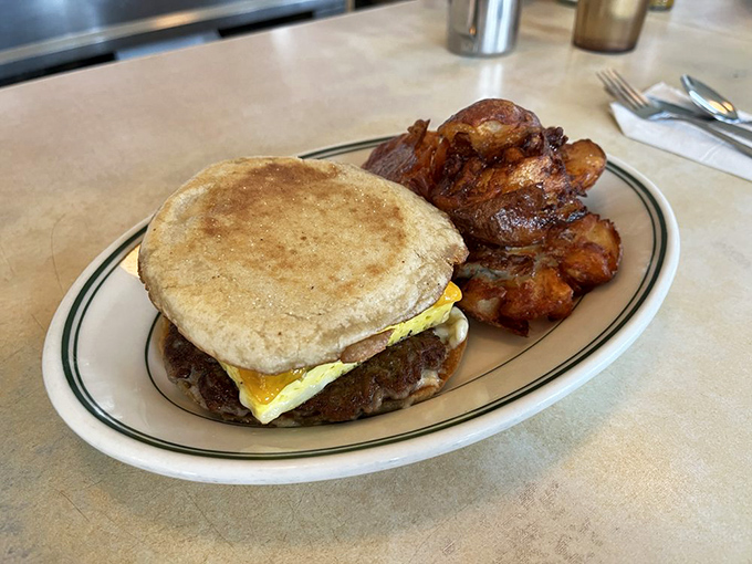 Breakfast sandwich perfection with home fries that deserve their own zip code. The kind of plate that makes Monday mornings bearable.