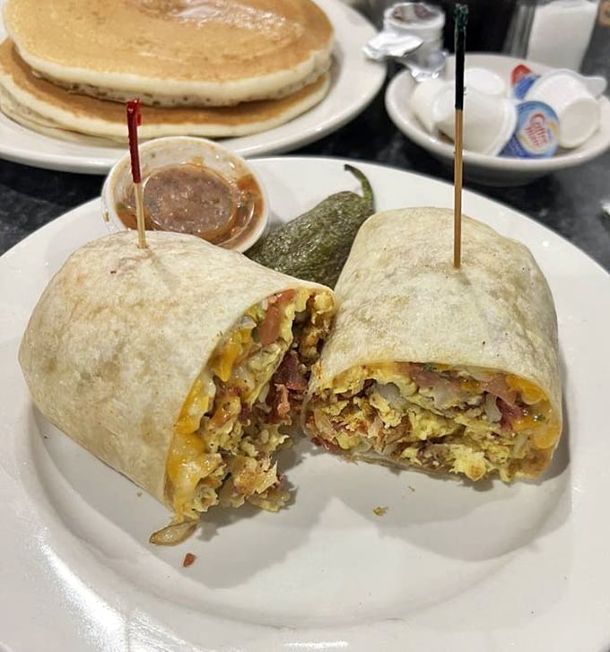 The breakfast burrito, sliced to reveal its treasure trove of fillings, sits alongside pancakes like breakfast's dynamic duo. No cape required.