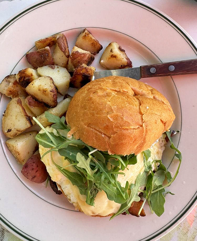 This isn't just a breakfast sandwich; it's a morning masterpiece with perfectly golden potatoes and fresh arugula for balance.