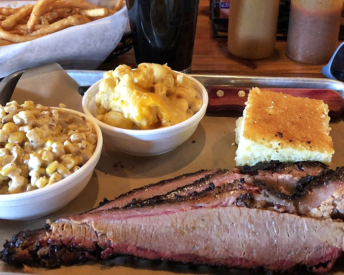 Brisket with that telltale pink smoke ring that makes Texans weep with joy. The cornbread and sides aren't just supporting actors—they're stealing scenes.