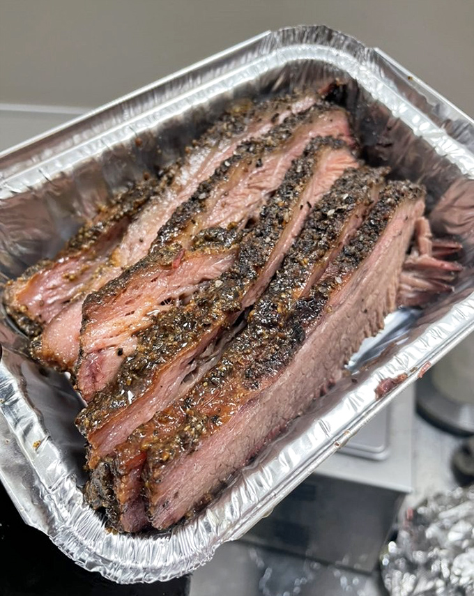 Brisket poetry: Perfectly sliced with that telltale smoke ring and peppery bark. Each piece tells the story of patience, smoke, and time-honored technique.