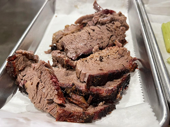 Brisket sliced so perfectly it could make a butcher weep. Each piece showcases that telltale smoke ring&mdash;nature's way of saying "you're welcome."
