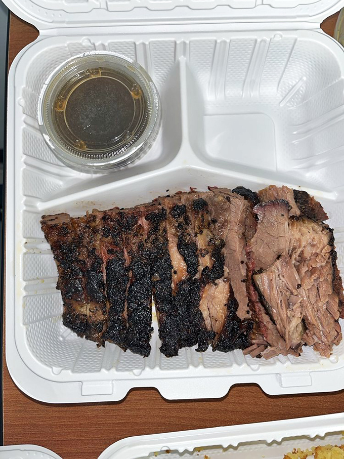 Brisket with that textbook smoke ring and perfect bark &ndash; the kind that makes Texans nod in reluctant approval.