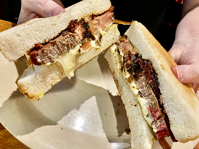The brisket melt reveals its glorious cross-section &ndash; a harmony of tender meat and melted cheese that makes bread the luckiest food group.
