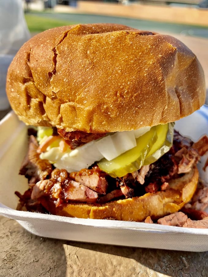 The brisket sandwich that launched a thousand return trips. Tender smoked meat, tangy pickles, and onions on a pillowy bun&mdash;simple perfection.