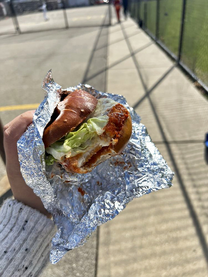 This isn't just lunch&mdash;it's a crispy, savory masterpiece where pretzel dough meets crispy chicken and fresh lettuce for sidewalk dining perfection.