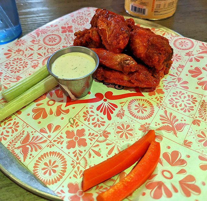 Buffalo wings that could make a Buffalonian weep with joy, served with the kind of blue cheese dip that deserves its own fan club.