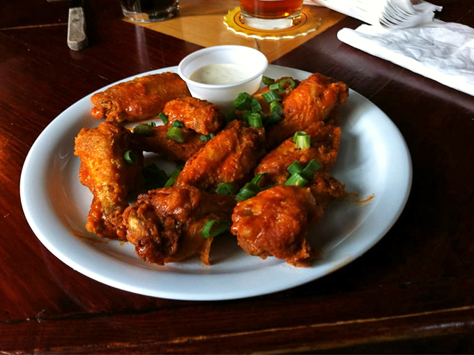 These buffalo wings aren't just crispy&mdash;they're having a meaningful relationship with that sauce while the green onions add a fresh pop of color.