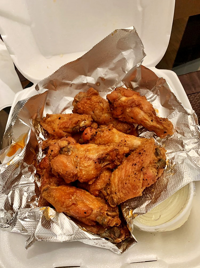Buffalo wings done right - crispy, saucy, and requiring at least twenty napkins per order.