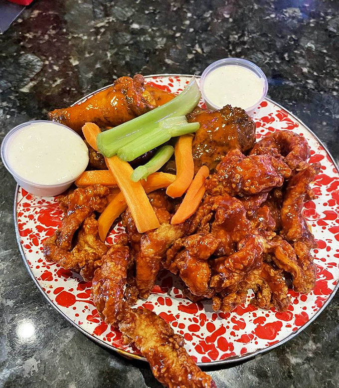 These wings aren't just buffalo-style, they're a masterclass in the art of crispy-outside, juicy-inside perfection with cooling dips standing by.
