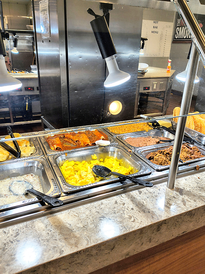 The breakfast buffet spread showcases scrambled eggs, hash browns, and all the morning classics that make early rising actually worthwhile for once.