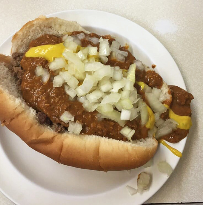 A close-up reveals the architectural marvel of meat, sauce, and onions that defines Detroit dining.