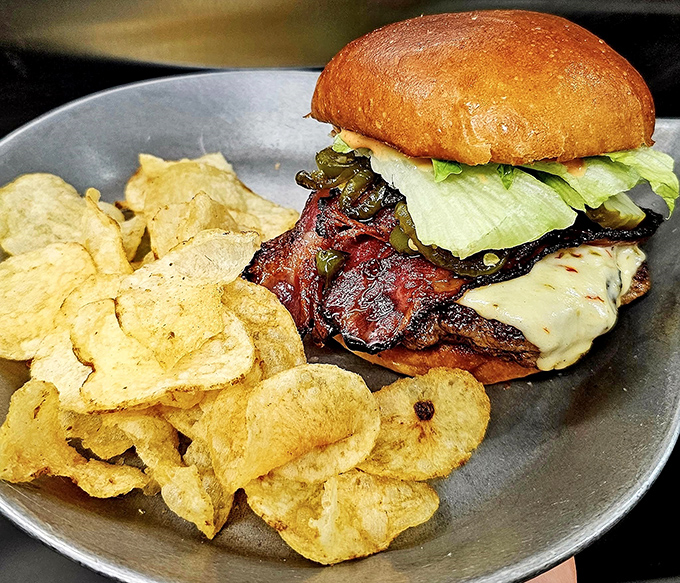 This isn't just a burger &ndash; it's a masterpiece of melted cheese, crispy bacon, and fresh veggies that requires both hands and zero regrets.