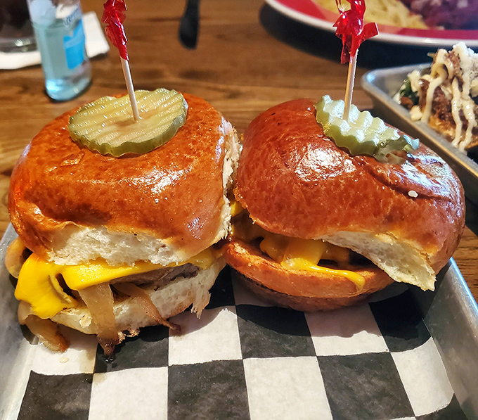 These sliders aren't just mini burgers; they're flavor bombs topped with pickles standing guard like tiny sentinels.