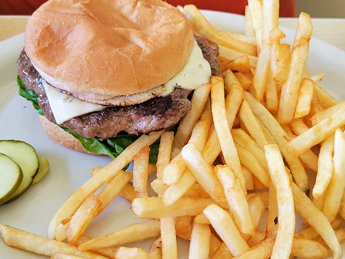 The classic American burger and fries&mdash;proof that simplicity, when done right, needs no improvement. That pickle slice is the exclamation point on a perfect sentence.